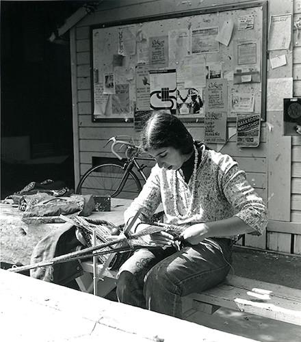 Textiles student at work in front of Studio 7, 1976 — Calisphere