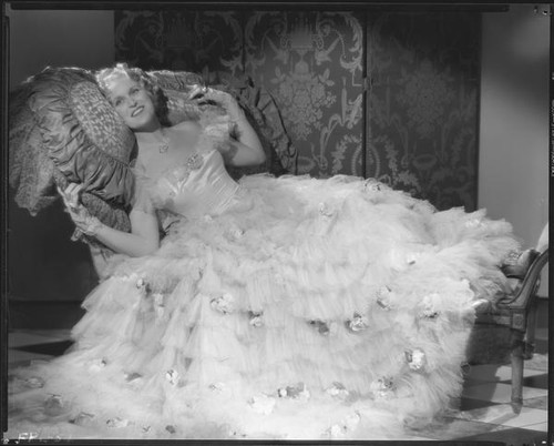 Peggy Hamilton modeling a Travis Banton gown with a full skirt of white ...