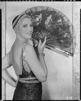 Peggy Hamilton modeling an Earl Luck blue sequin dinner gown and cap ...