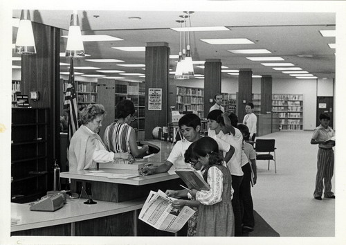 Library patrons and workers at the Central Library in Commerce — Calisphere