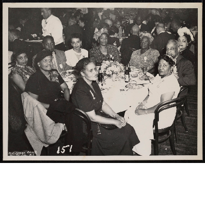 Seated at dining table (left-right): Carolyn McWatt, Rosina C. Tucker ...
