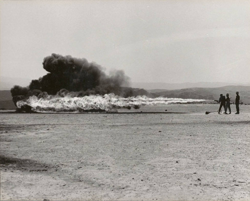 Photograph of soldiers using a flamethrower — Calisphere