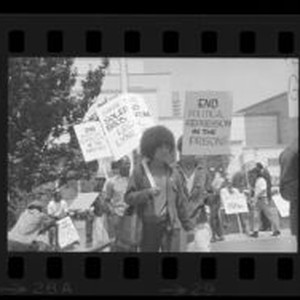 Jonathan Peter Jackson (face obscured by sign) walking with Angela ...