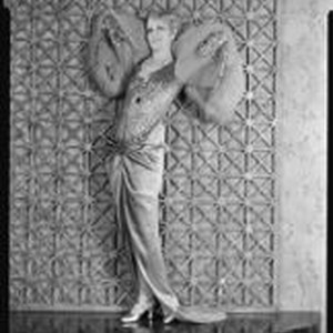 Peggy Hamilton modeling a Max Rée hostess gown of apple-green satin and ...