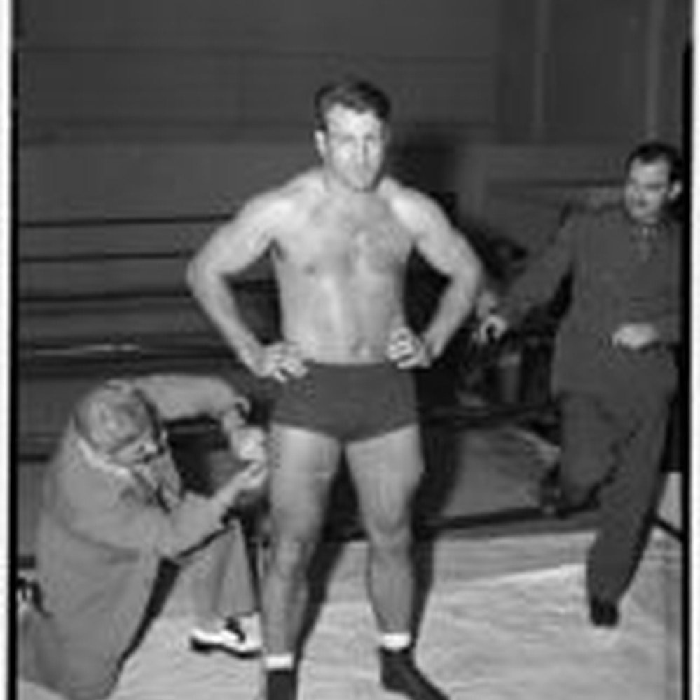 Wrestler and football player Bronko Nagurski having his thigh measured before a wrestling match at Wrigley Field Los Angeles August 11 1937 Calisphere