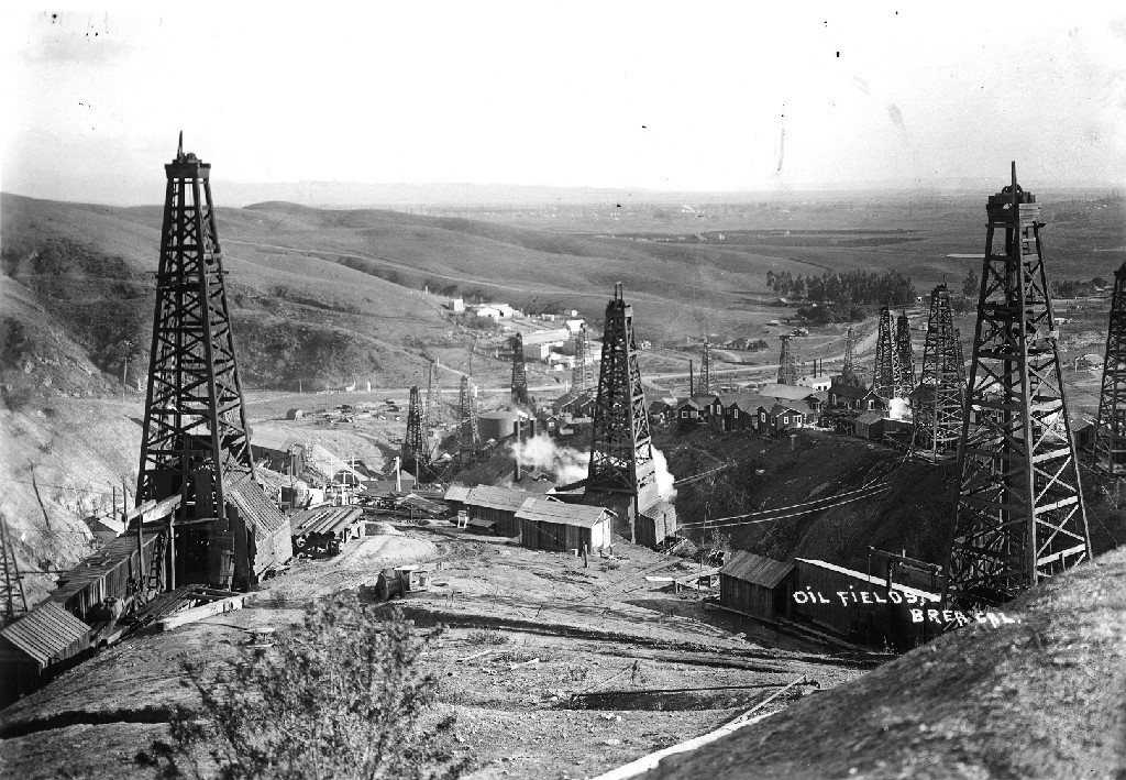 Panoramic view of oil field with three oil rigs in Brea, California ...