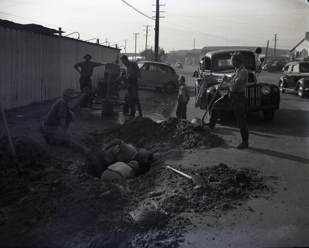 Men digging trench in the street for water pipes, Newport Beach ...