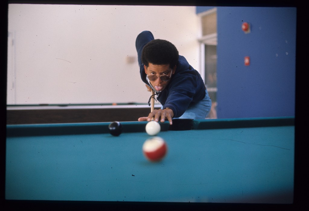 Male student playing pool, ca. 1970 — Calisphere