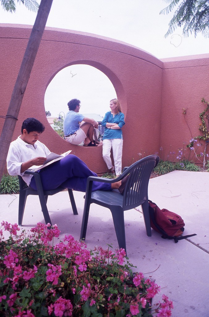 Students hanging out, outside of graduate student housing. — Calisphere