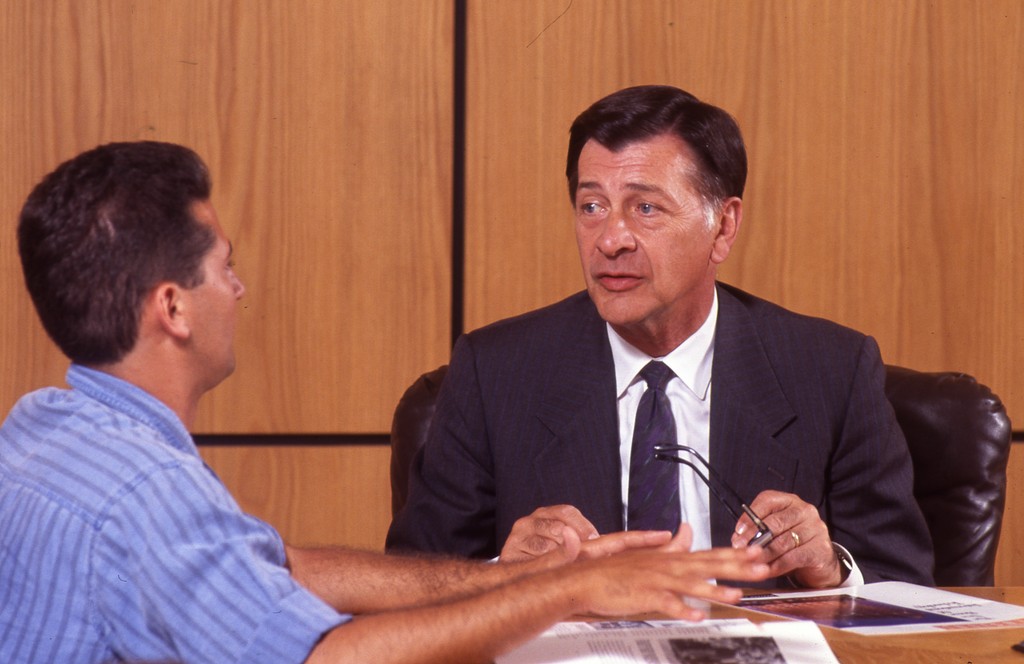 Roger Johnson speaking with a student. — Calisphere