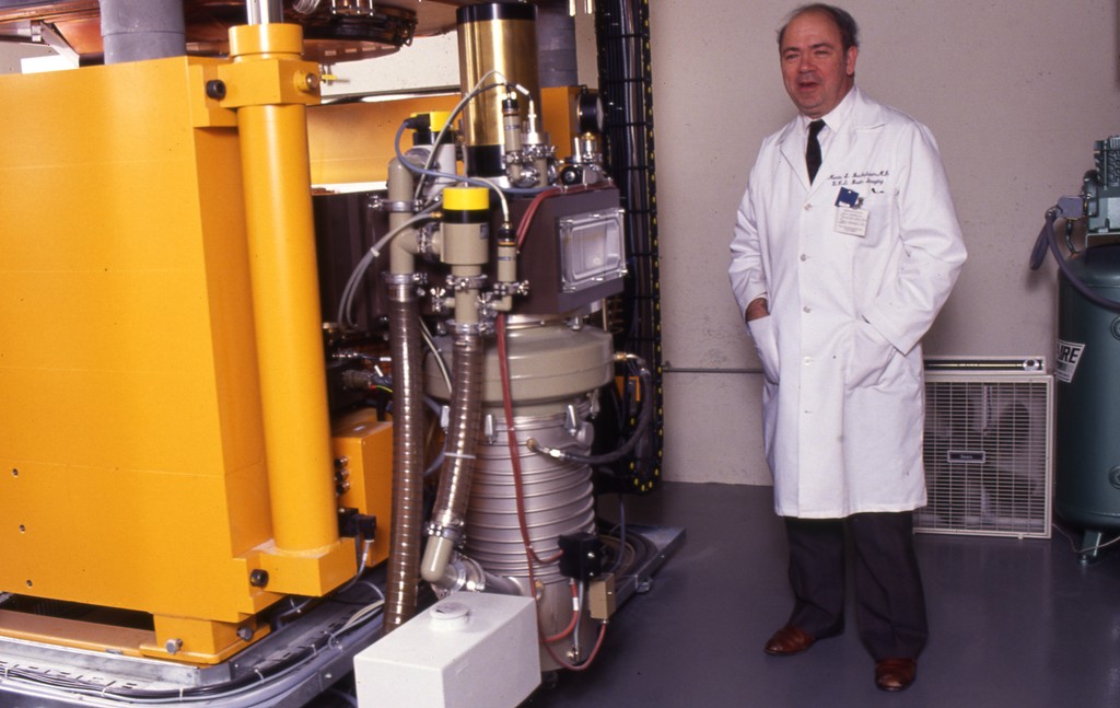 Professor Monte Buchsbaum, B.I.C., with cyclotron. — Calisphere