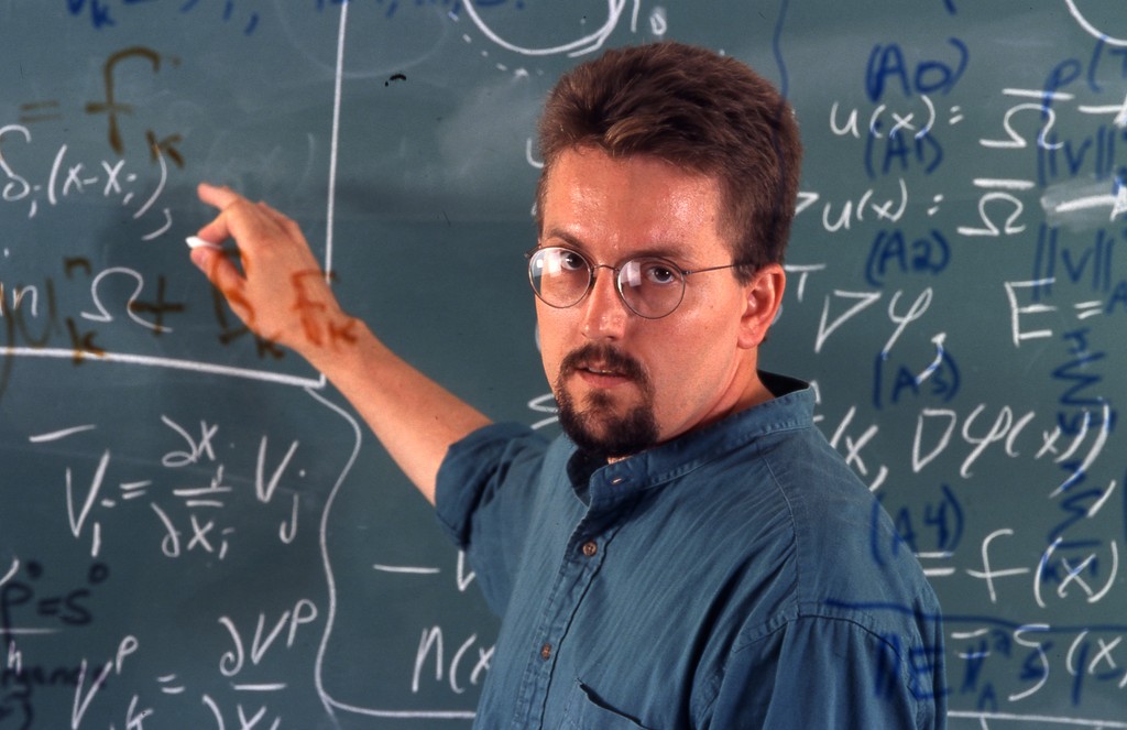 Professor Michael Holst, standing in front of a chalkboard. — Calisphere