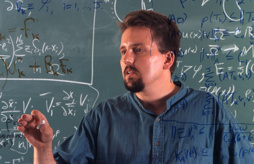 Professor Michael Holst, standing in front of a chalkboard. — Calisphere