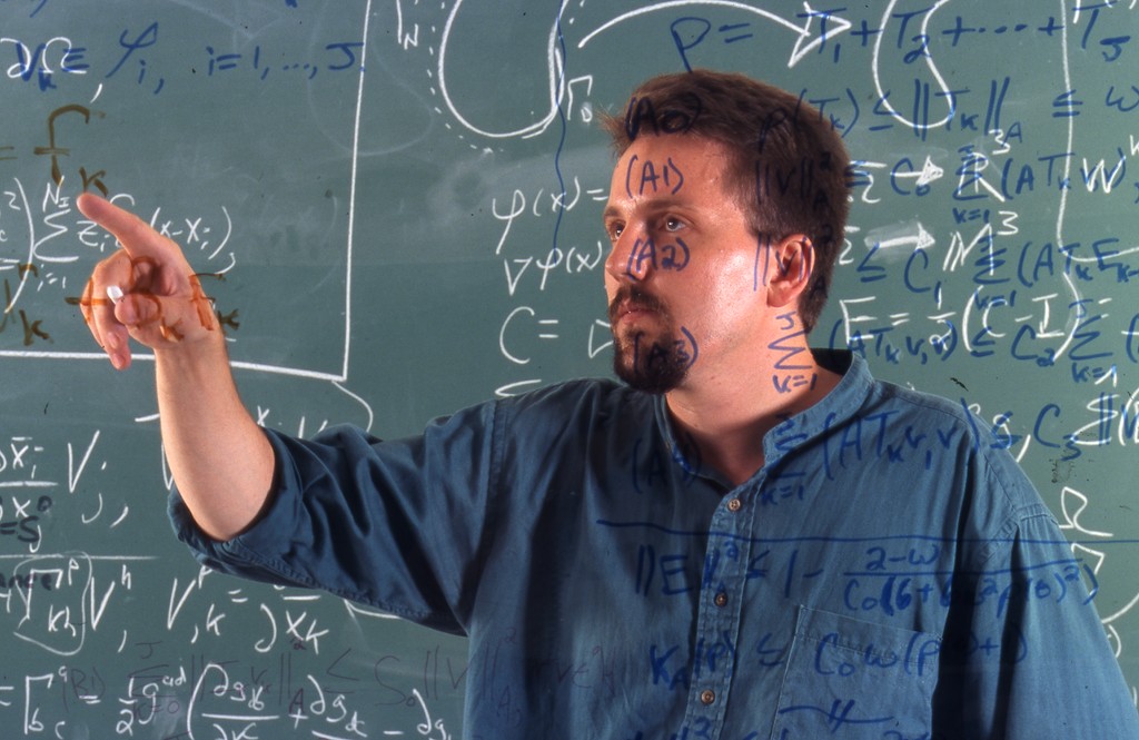 Professor Michael Holst, standing in front of a chalkboard. — Calisphere