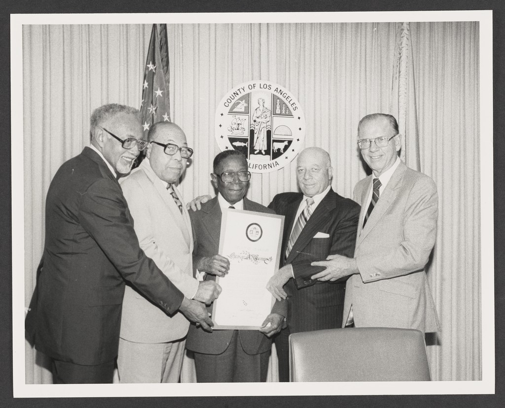 George A. Beavers, Jr. is presented with a resolution from the Los ...