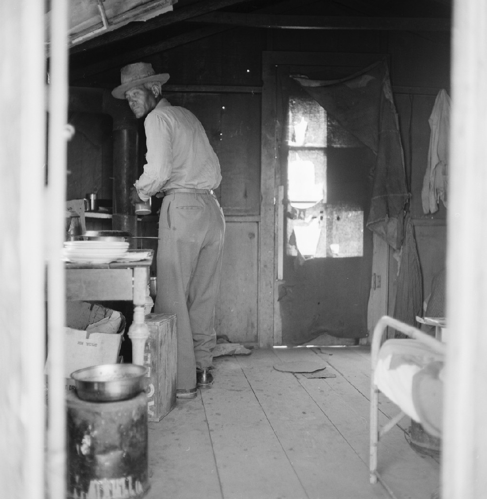 Man inside shack through doorway — Calisphere
