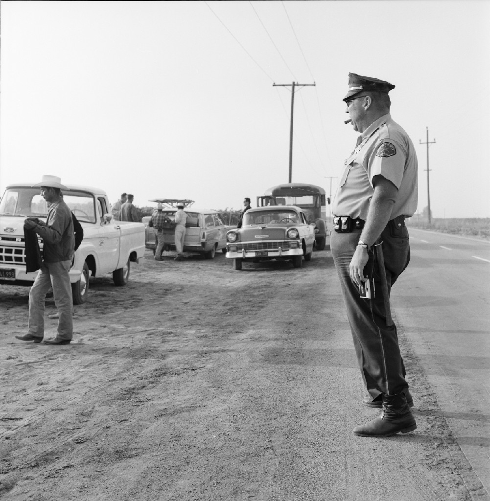 Policeman monitoring demonstration activities — Calisphere