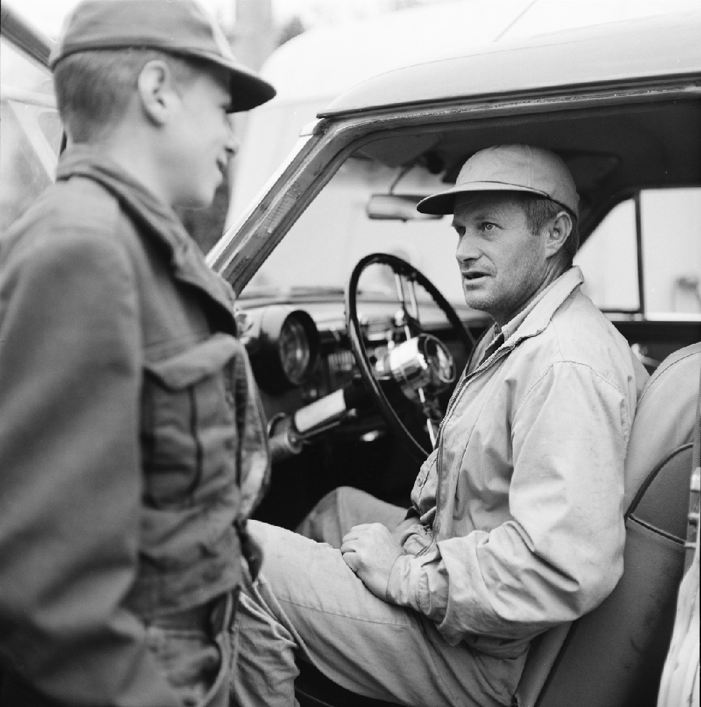 Dad & son talking at the car — Calisphere