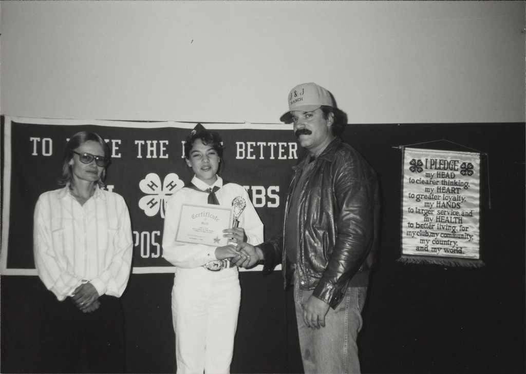 [Girl receives 4-H certificate of achievement] — Calisphere