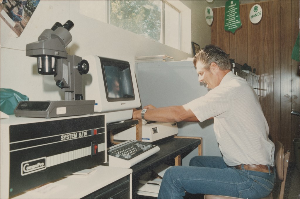 [Man setting up computer] — Calisphere